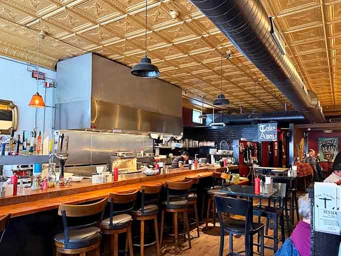 Industrial chic meets cozy pub vibes where tin ceilings and warm wood create the perfect fish-eating atmosphere.