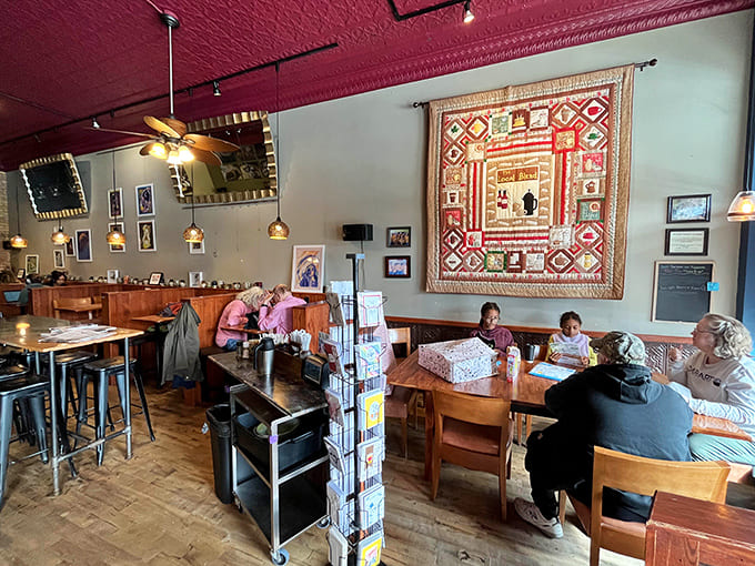 Inside, mismatched furniture and colorful walls create the kind of cozy chaos where great conversations and even greater pastries happen naturally.
