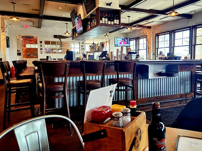 Pull up a chair at this inviting bar where corrugated metal meets warm wood, creating the perfect backdrop for swapping stories over craft beers.