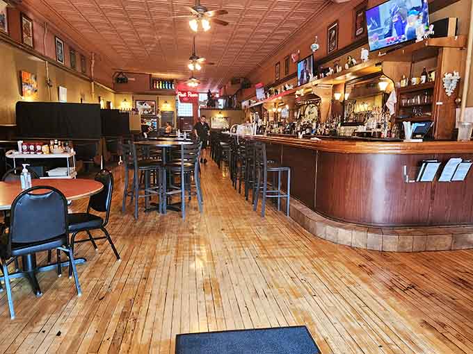 Those gleaming hardwood floors and tin ceilings create an atmosphere that's equal parts nostalgia and sophistication, perfectly balanced.