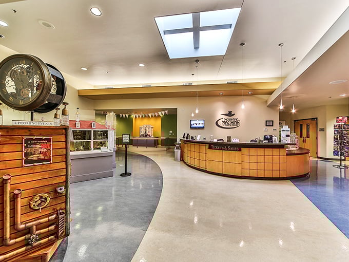 The welcoming lobby curves with warm wood tones and natural light, your first step into a world where everything familiar has been reimagined in miniature.