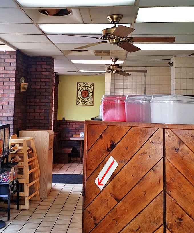 Classic red counter stools line the narrow interior, offering front-row seats to the breakfast theater happening on the grill.