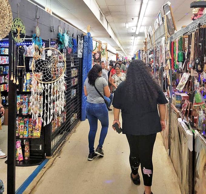 Shoppers navigate the labyrinth of vendor stalls, where dreamcatchers dangle overhead like retail fishing lures for the imagination-inclined treasure hunter.