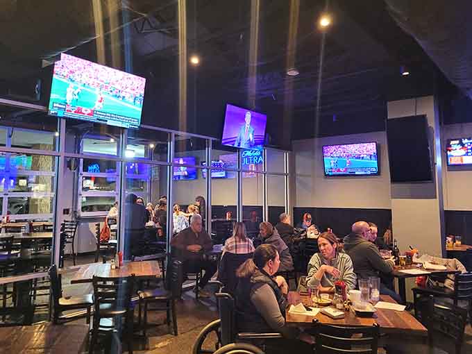 The contemporary tavern interior balances industrial chic with genuine warmth, perfect for any dining occasion.