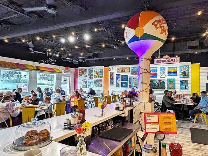 Inside Native Cafe, colorful chairs and beach-inspired decor create a festive atmosphere, while a whimsical Pensacola Beach ball hangs from the ceiling like a coastal chandelier.
