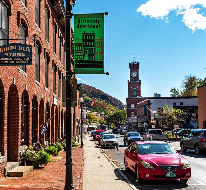 Definitely downtown! proclaims the banner, with the historic clock tower rising above brick buildings that have witnessed centuries of Vermont life.