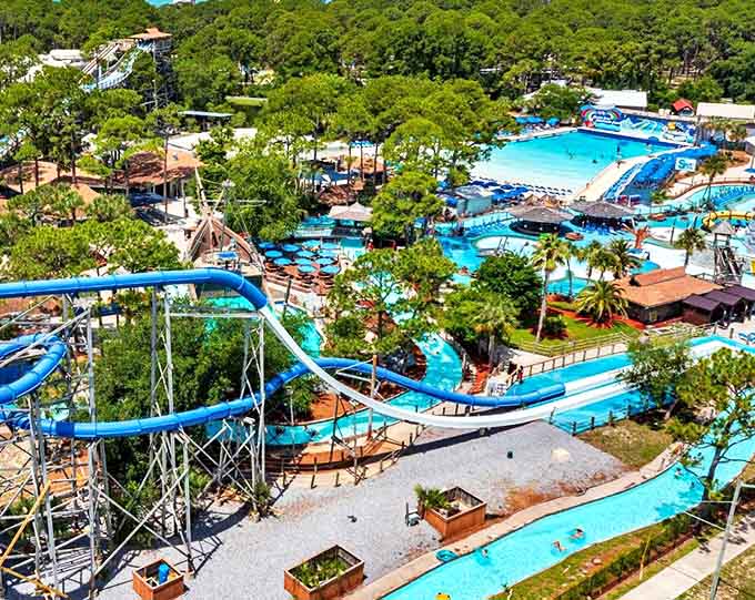 An elevated view reveals Shipwreck Island's masterful design &ndash; a blue oasis nestled among towering pines, promising adventures for water lovers of all ages.