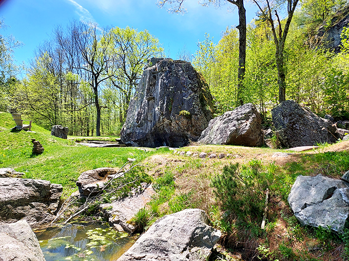 Ancient boulders stand sentinel in dappled sunlight, nature's sculpture garden that predates human hands by millennia.