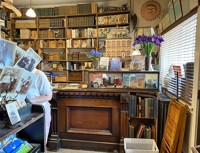 A bibliophile's dream: the checkout counter surrounded by floor-to-ceiling shelves, where every transaction comes with a story.