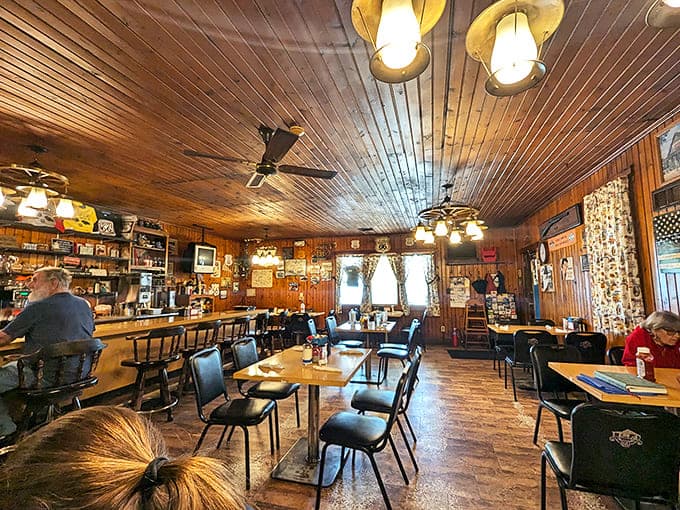 Warm wood paneling from floor to ceiling creates that authentic cabin feel, where conversations flow as freely as the coffee.