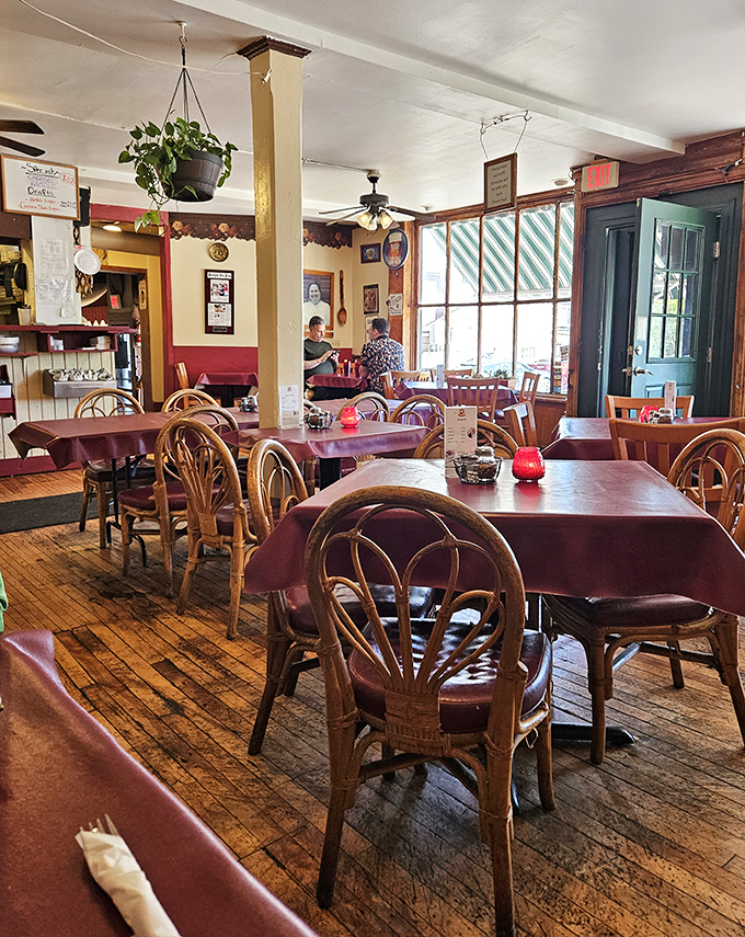 Inside Papa Frank's, wooden floors and burgundy tablecloths create that "nonna's dining room" vibe that makes every meal feel like Sunday dinner.