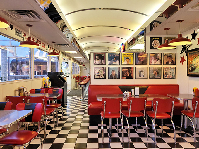Red vinyl booths and checkerboard floors create the perfect backdrop for comfort food conversations, while vintage memorabilia watches over satisfied diners.