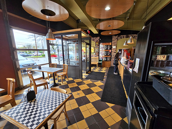 The checkerboard floor and warm lighting create that perfect "neighborhood joint" atmosphere where serious eaters gather for life-changing barbecue moments.