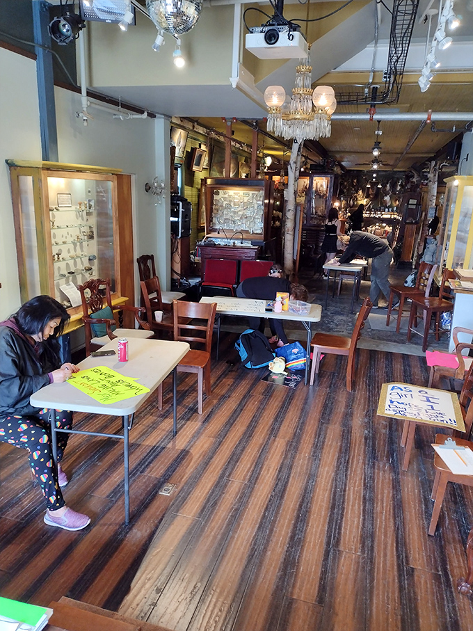 Wooden floors and vintage furnishings create the perfect backdrop for this cabinet of curiosities, where visitors work on projects amid the oddities.