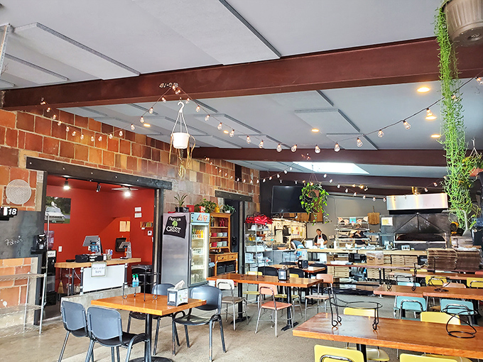 Inside, string lights and colorful chairs create the perfect backdrop for pizza magic to unfold.