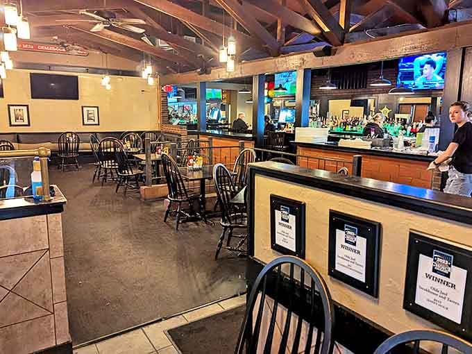 Exposed wooden beams and warm lighting create an inviting atmosphere in the main dining area, where history and comfort come together like old friends.