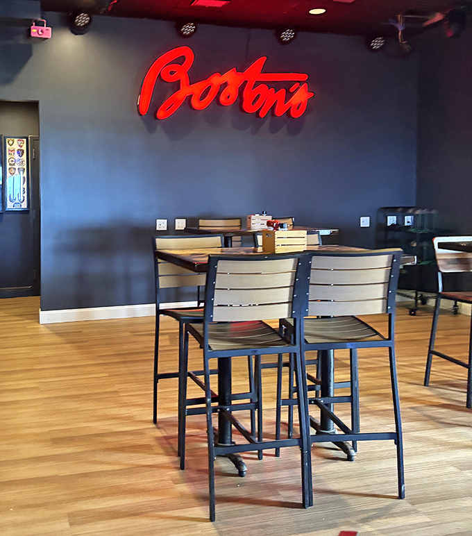 Modern meets nostalgic in the sleek interior where comfortable seating and Boston's signature red glow create the perfect dining atmosphere.