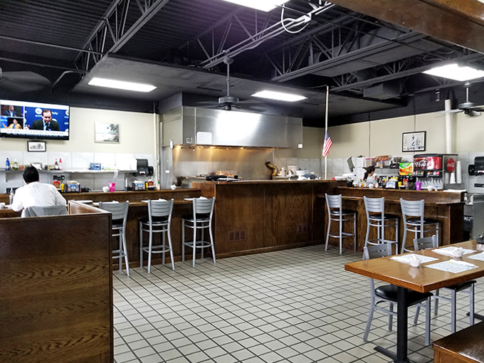 Classic diner counter seating invites solo diners to enjoy front-row views of breakfast magic in the making.