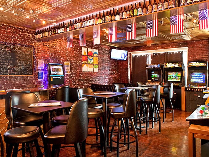 Exposed brick walls and vintage arcade glow create the perfect atmosphere for adults who refuse to fully grow up, bless them.