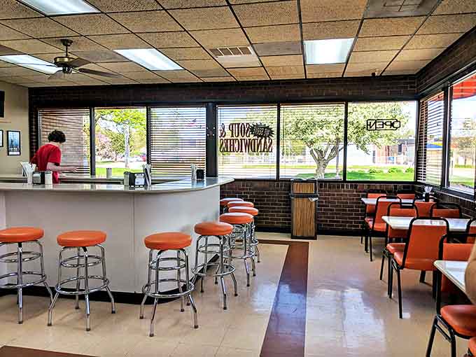 Those orange stools and booths create a retro diner vibe that says "sit down, relax, and prepare for something wonderful."