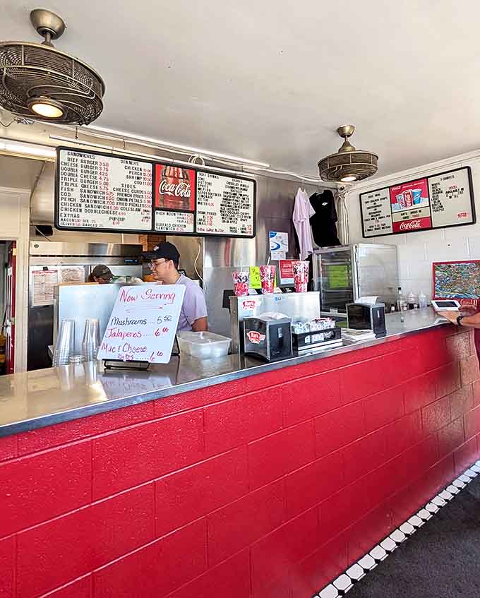 Behind the vibrant red counter, magic happens. The no-nonsense interior focuses on what matters most &ndash; creating food that keeps generations coming back.