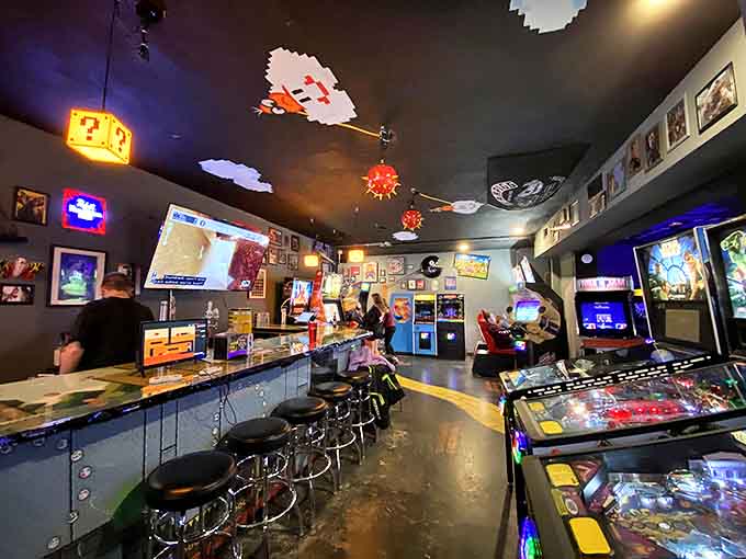 Step into a gamer's paradise where the glow of arcade screens meets the warm ambiance of question mark block lights dangling from above.