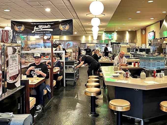 Classic diner counter seating where the coffee flows freely and the staff knows your order before you finish saying it.