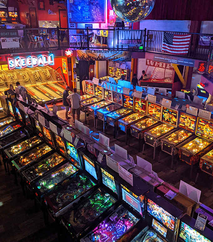 A pinball paradise stretches before you – rows of machines standing at attention like soldiers in a blinking, dinging army of fun.