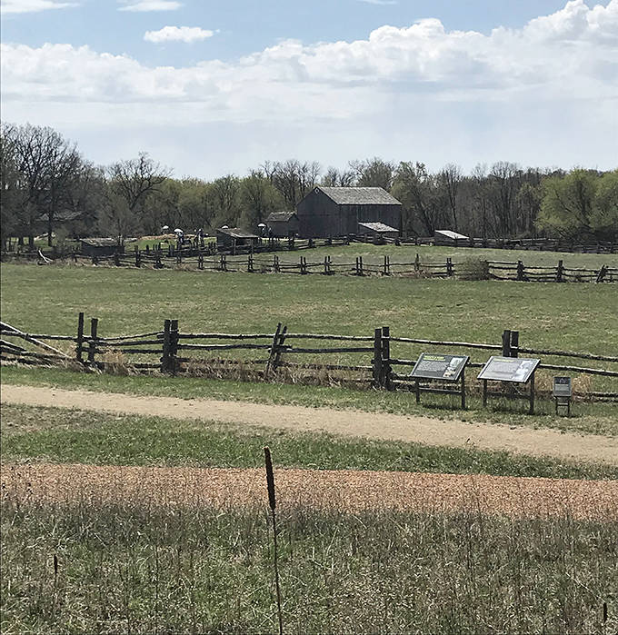 Rustic split-rail fences frame the pastoral landscape where history breathes through every weathered post and sun-dappled field.