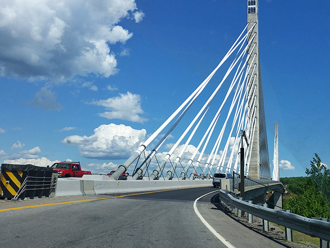 The graceful curves and supporting cables create a striking silhouette against Maine's brilliant blue skies &ndash; architectural poetry in motion. 