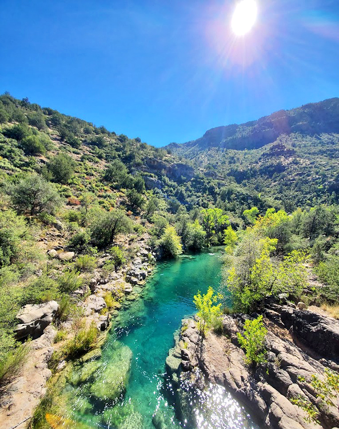 Top view of Fossil Creek: The bird's eye perspective reveals nature's artistry &ndash; a winding ribbon of turquoise cutting through rugged canyon walls.