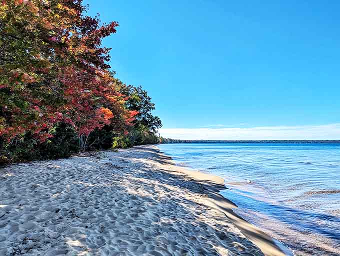Pristine white sand meets the crystal waters of Lake Superior, creating a beach experience that rivals any coastal paradise.
