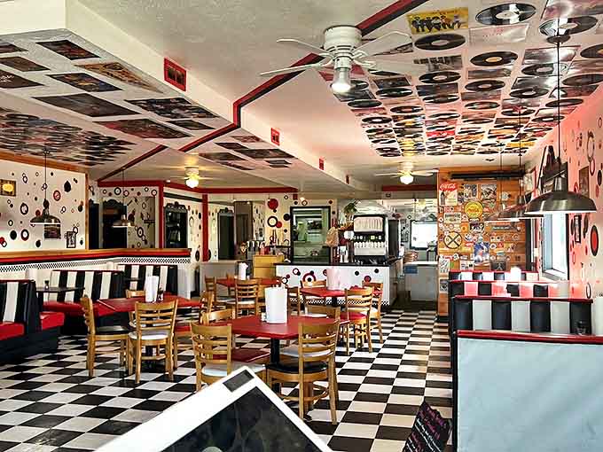 Step into a time machine of taste with this retro interior where vinyl records and checkered floors set the stage for burger bliss.