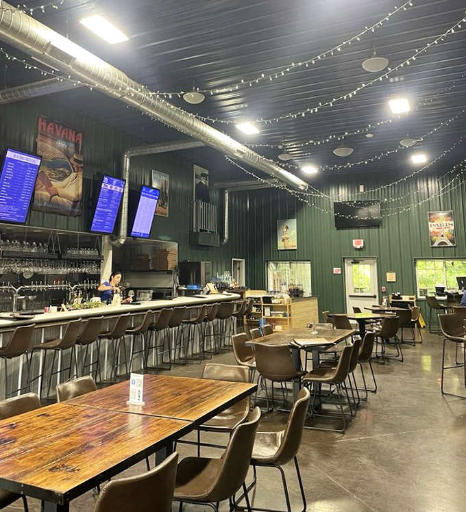 String lights dance across the industrial ceiling, creating an atmosphere that's somehow both hangar-chic and intimately inviting.