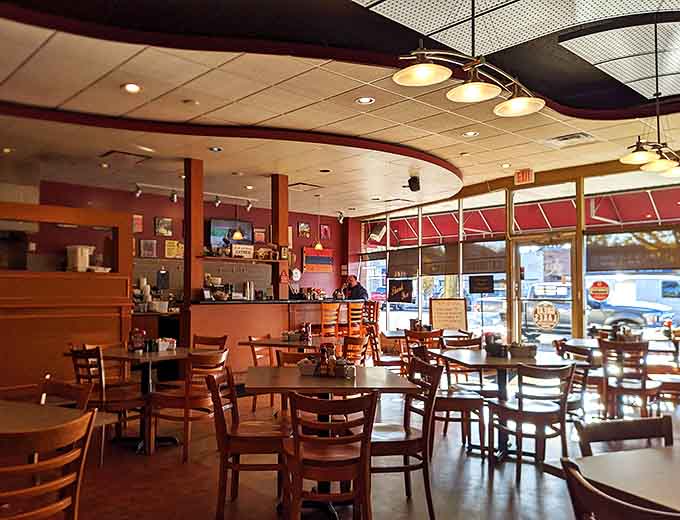 Warm burgundy walls and wooden furnishings create that perfect "everybody knows your name" atmosphere where breakfast memories are made daily.