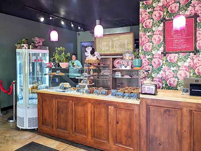Behind this wooden counter lies the gateway to French culinary bliss, complete with floral wallpaper that would make your grandmother swoon with approval.