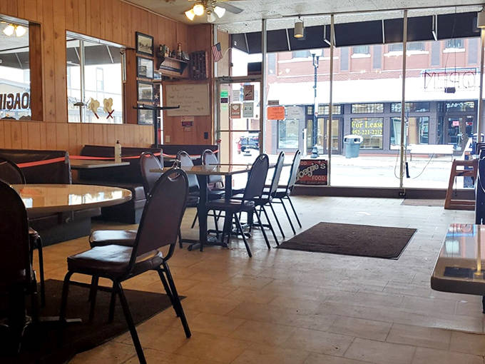 Wood-paneled walls and comfortable seating create that perfect small-town diner atmosphere where conversations flow as freely as the coffee.