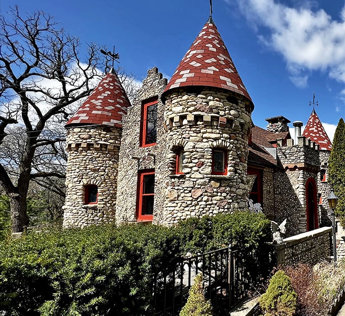 Bettendorf Castle's stone towers and distinctive red-capped turrets create a storybook silhouette against the blue sky, looking like it was plucked straight from the European countryside.