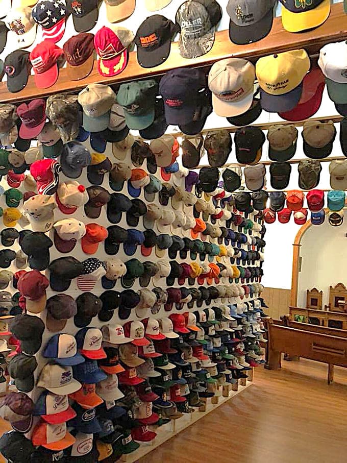 Baseball caps create a rainbow wall that stretches from floor to ceiling at Jerry's Hat Museum.