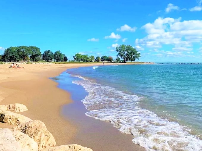The expansive shoreline at Simmons Island Beach offers plenty of room to spread out, with water that shifts between emerald and sapphire.
