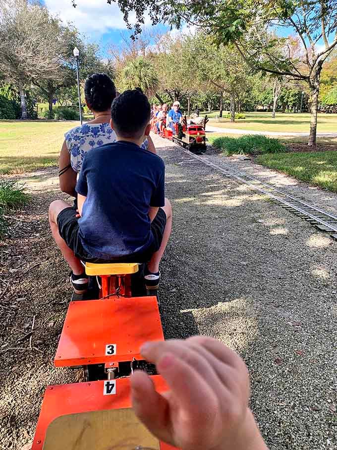 Young passengers and their families eagerly await their turn for adventure, the excitement of the impending journey written across their faces.