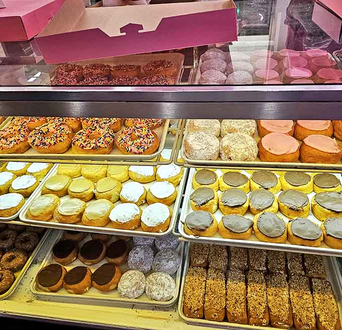 Trays of golden-brown delights glisten under display lights &ndash; each pastry a testament to the bakery's commitment to traditional methods and quality ingredients.