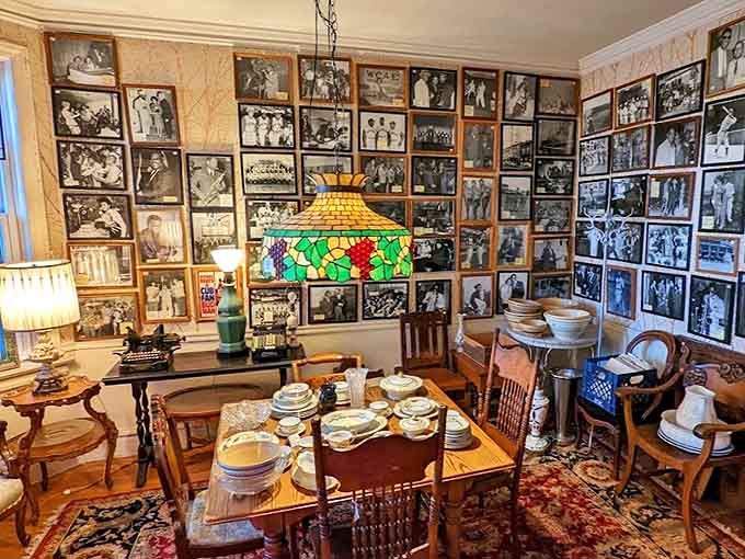 Every wall tells stories through photographs, while Tiffany-style lamps cast warm, colored light on antique furnishings.