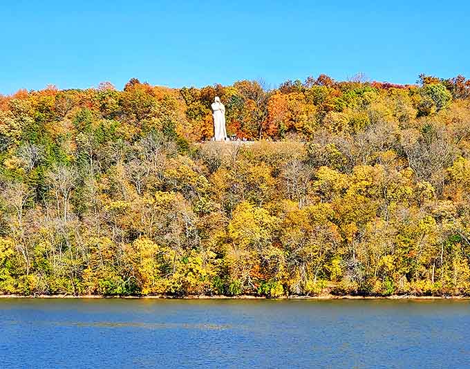 From the river below, the statue appears to command the entire valley – a concrete monarch surveying its leafy kingdom.