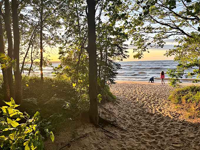 Golden hour transforms the shoreline into a pathway of light, where visitors pause to witness nature's daily masterpiece.
