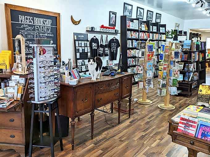 Antique furniture adds character throughout the store, with this vintage sideboard serving as both functional checkout counter and display for literary treasures.