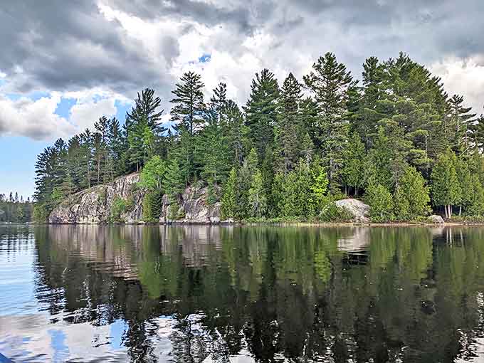 Ancient granite shorelines stand sentinel over Craig Lake, their weathered faces telling geological stories spanning millions of years.