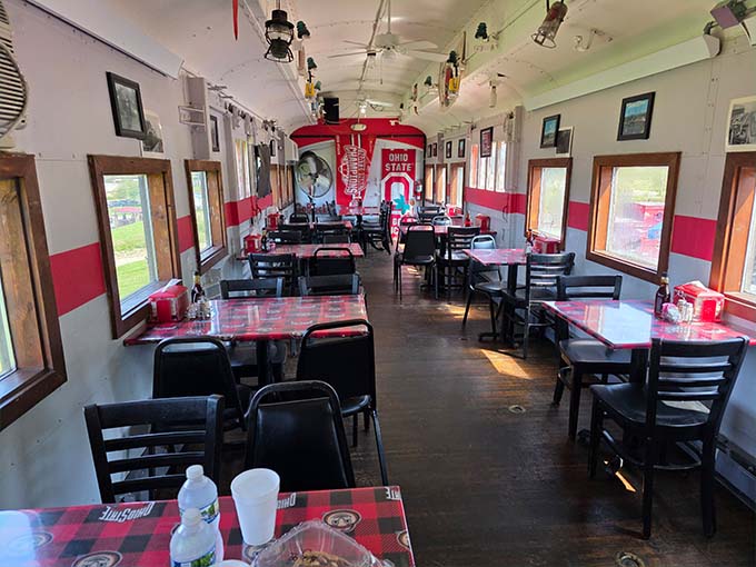 The authentic train car interior maintains its curved ceiling and narrow dining space, transporting guests to the golden age of rail travel.