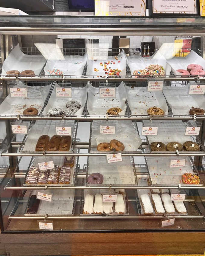 Donut heaven organized in neat rows &ndash; each labeled variety promising its own unique journey of flavor and texture.