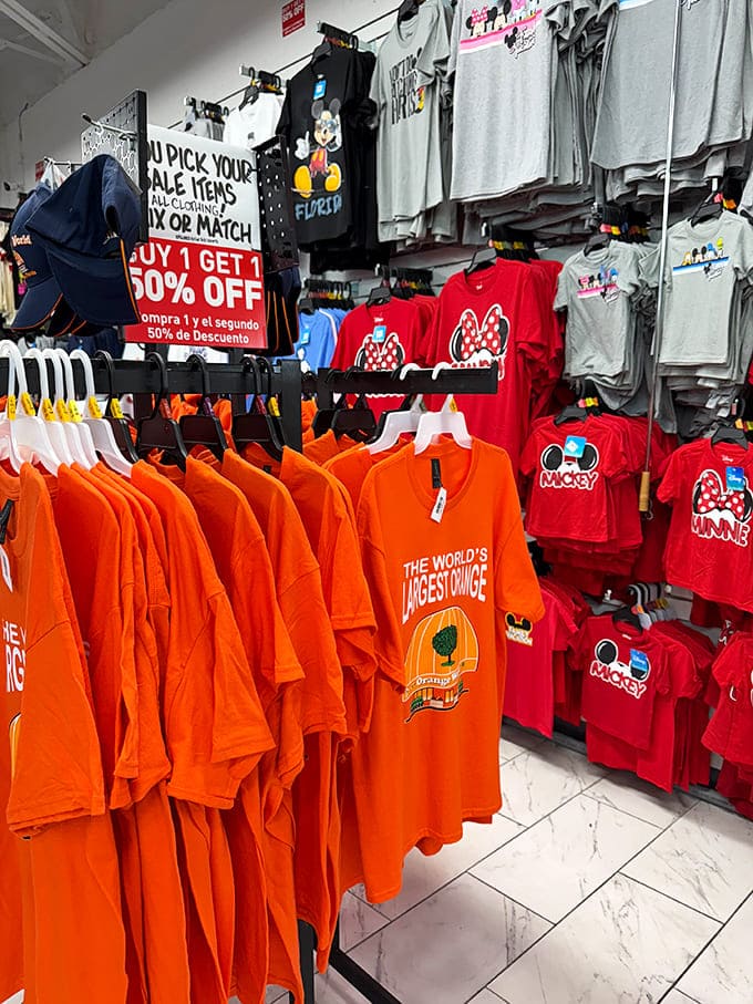The clothing section bursts with vacation-ready apparel, where Mickey Mouse shares rack space with proclamations of citrus superiority.